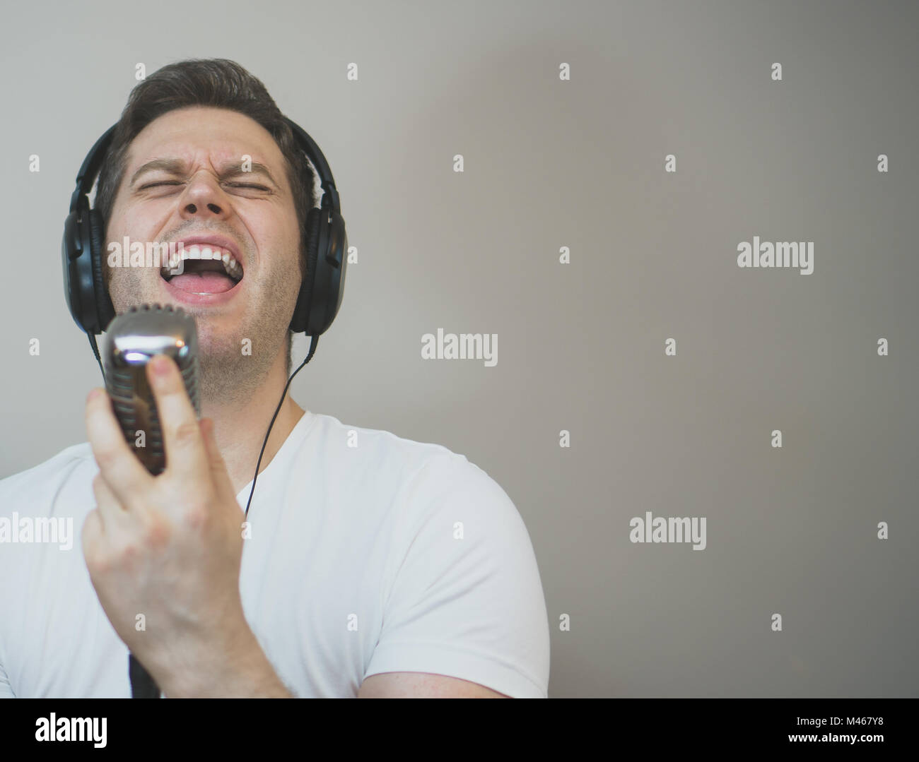 Handsome man recording a song. Space for your text Stock Photo - Alamy
