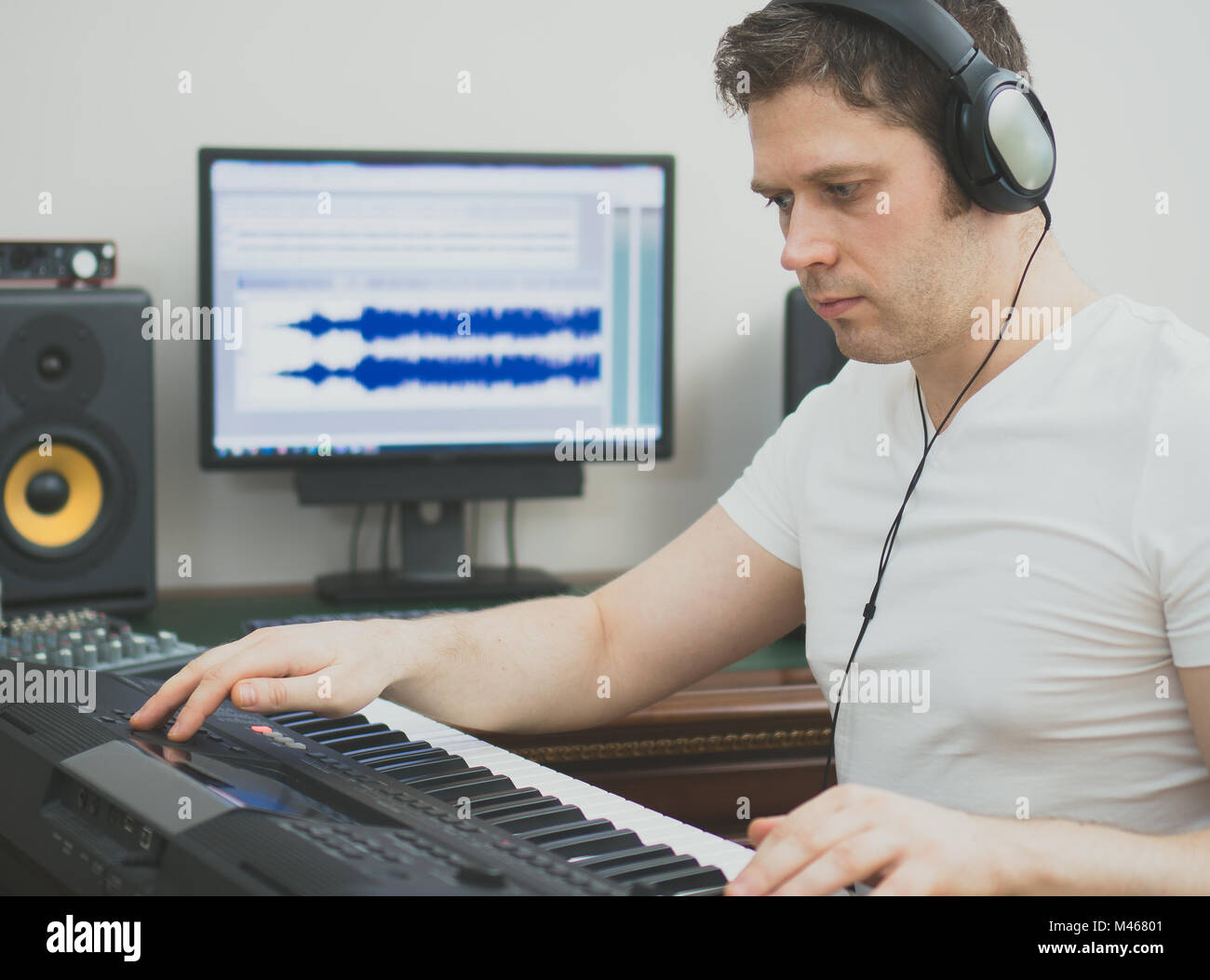 Handsome man recording song in music studio Stock Photo - Alamy