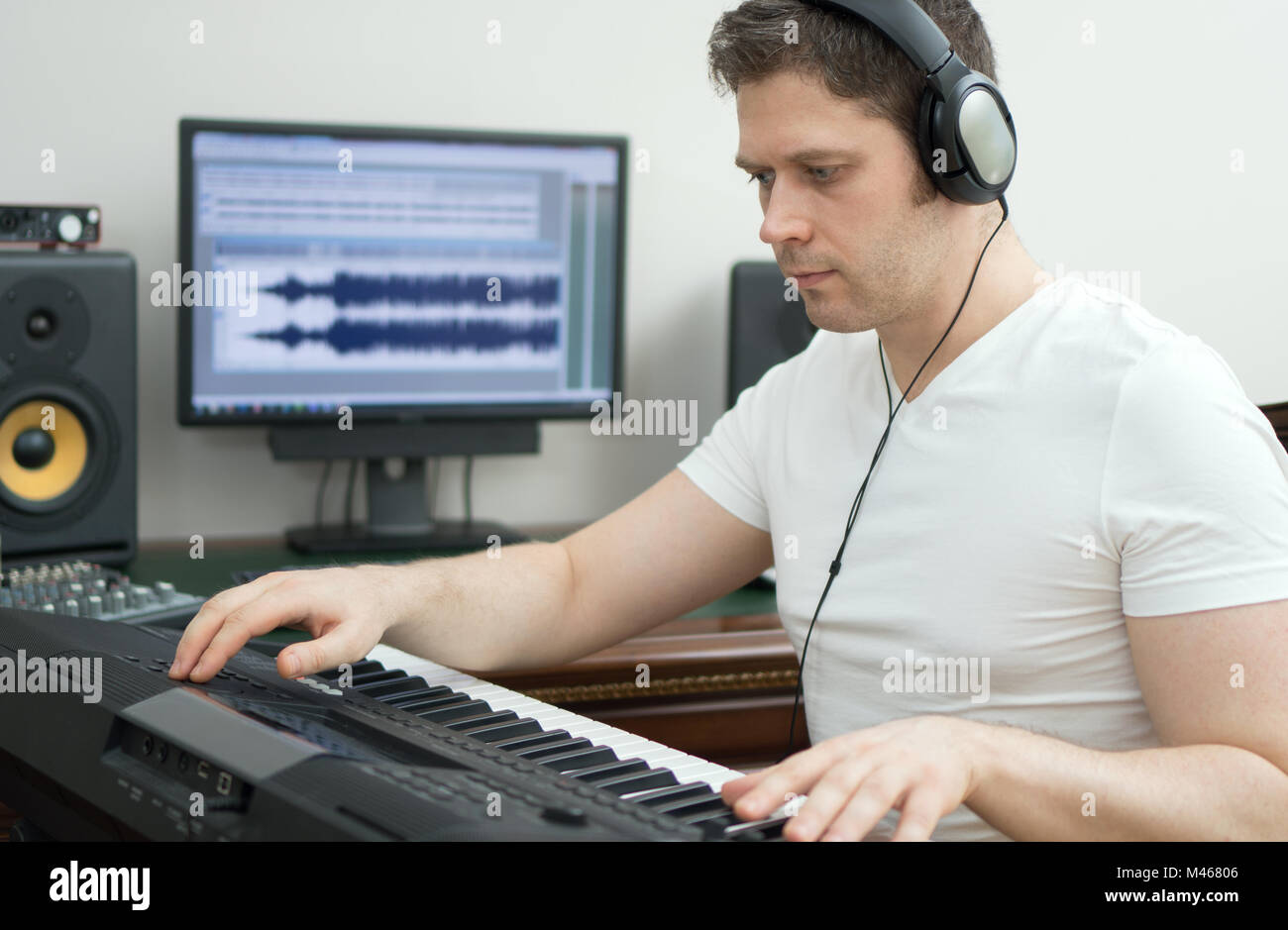 Handsome man recording song in music studio Stock Photo - Alamy