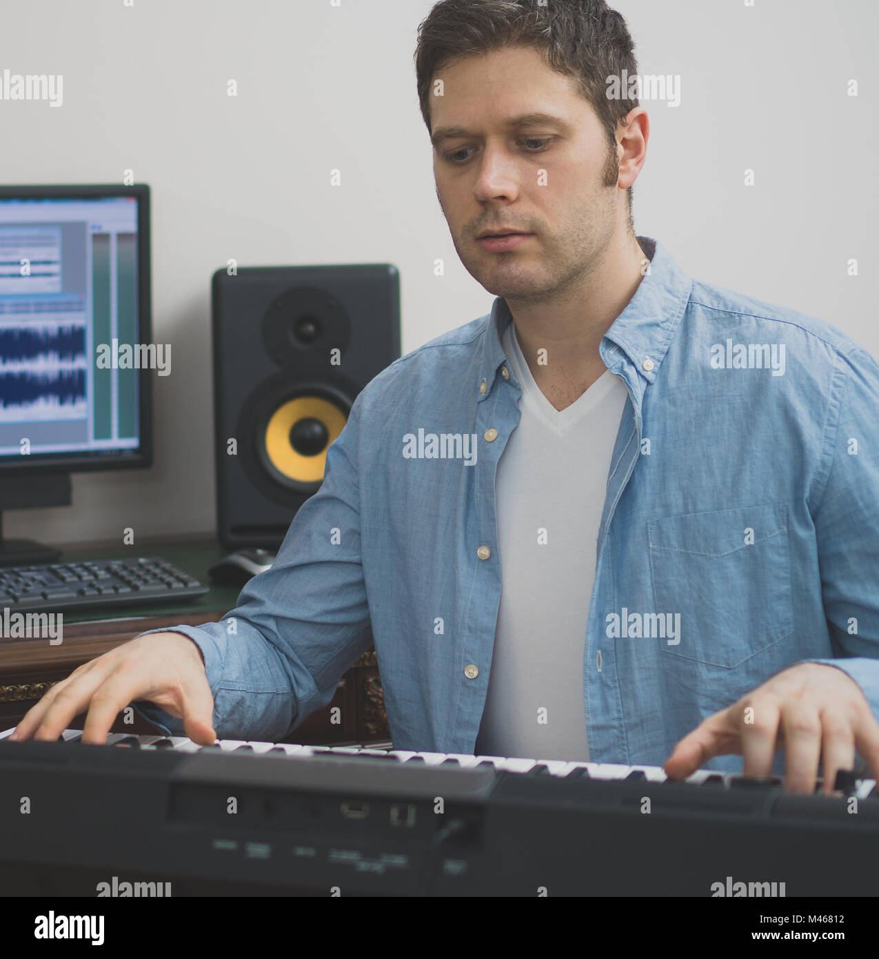 Handsome man recording song in music studio Stock Photo - Alamy