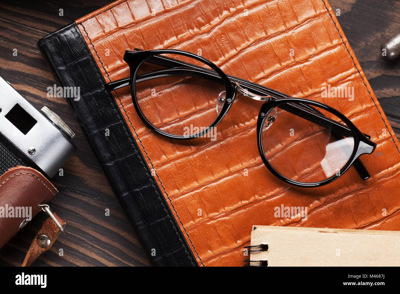 Retro table with vintage items. Camera, notepad, glasses. Top view ...
