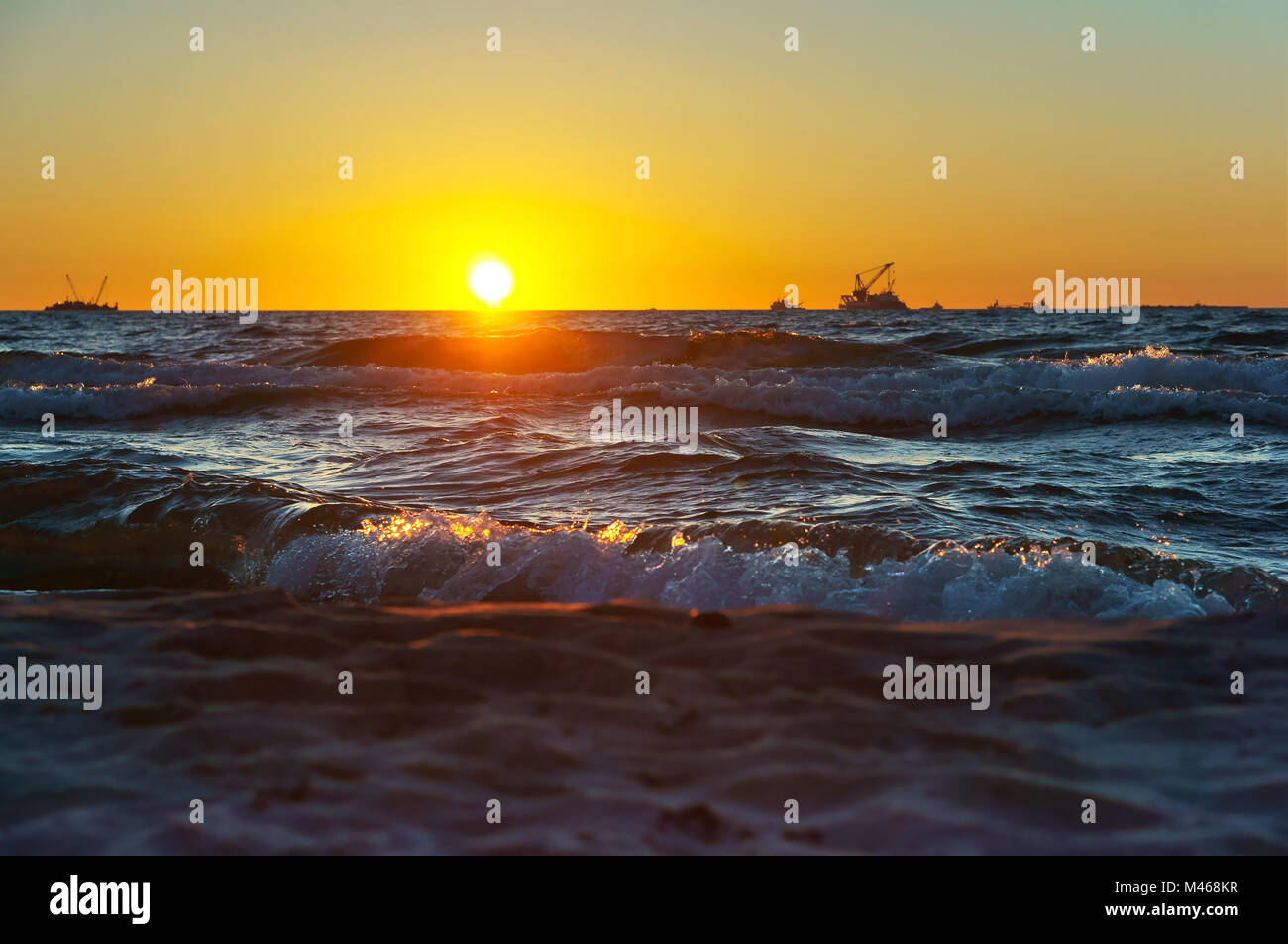 Sunset over the sea. Reflection of sunlight in the sea waves. Red sky ...