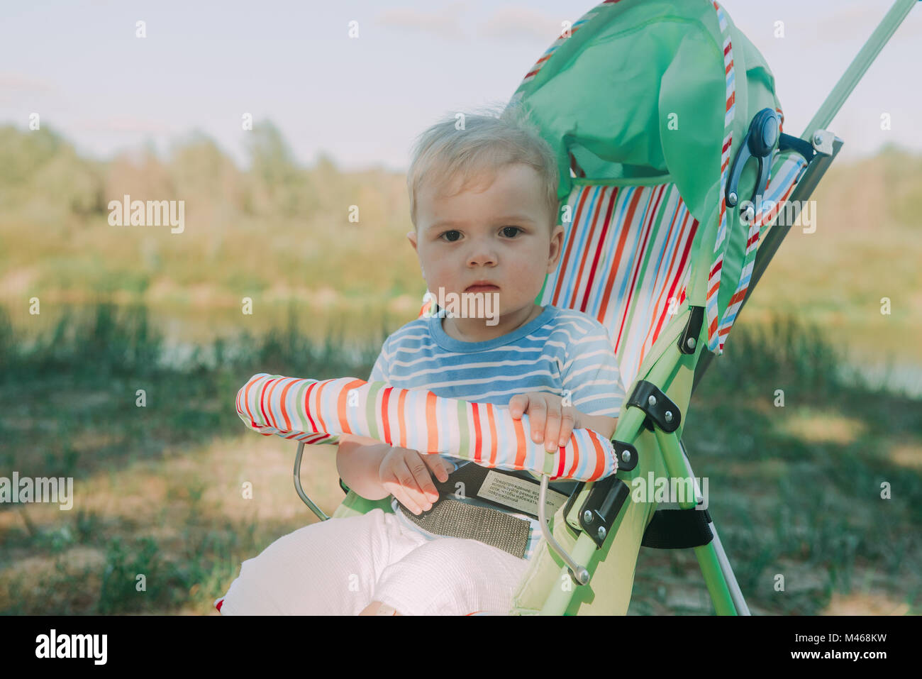 beautiful baby sitting in a pram outdoors Stock Photo - Alamy