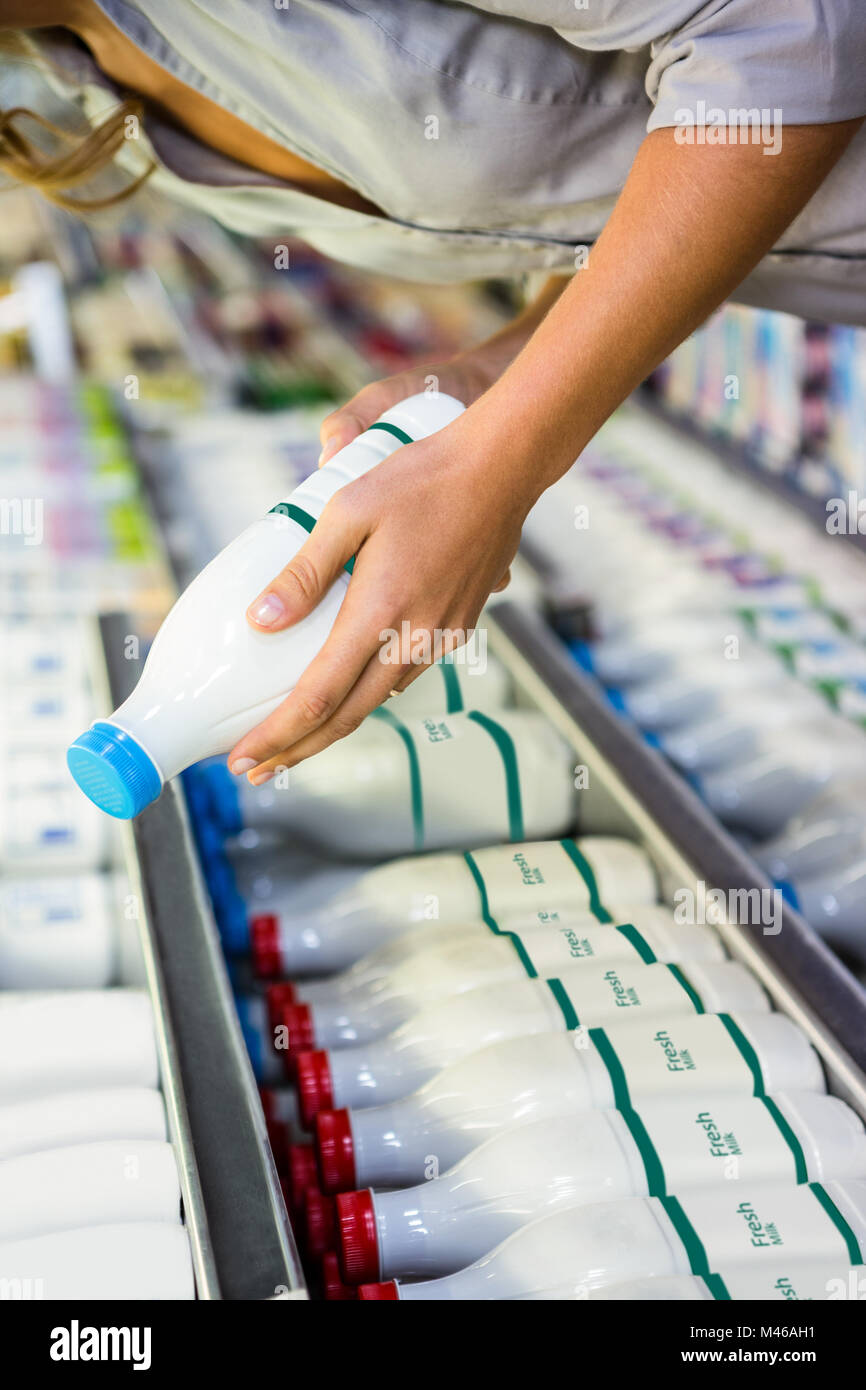 Woman reading the ingredient on a milk bottle Stock Photo - Alamy