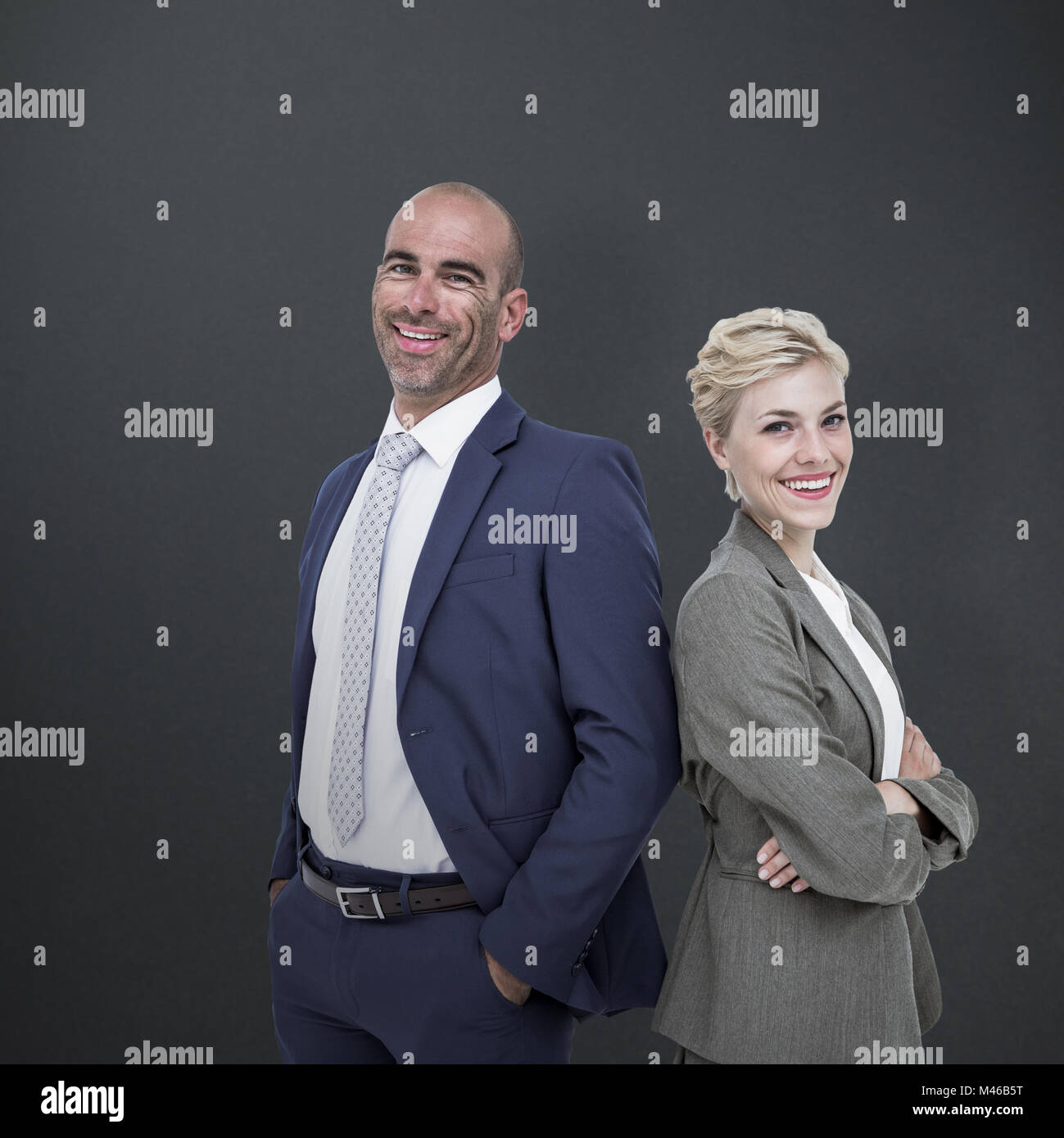 Composite image of smiling business people back-to-back Stock Photo - Alamy