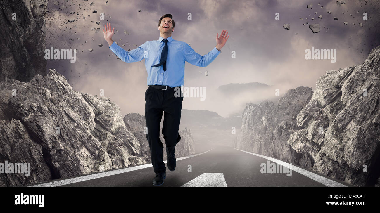 Composite image of happy businessman running with hands up Stock Photo ...