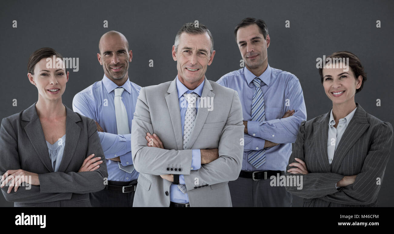 Composite image of business team working happily together on laptop ...