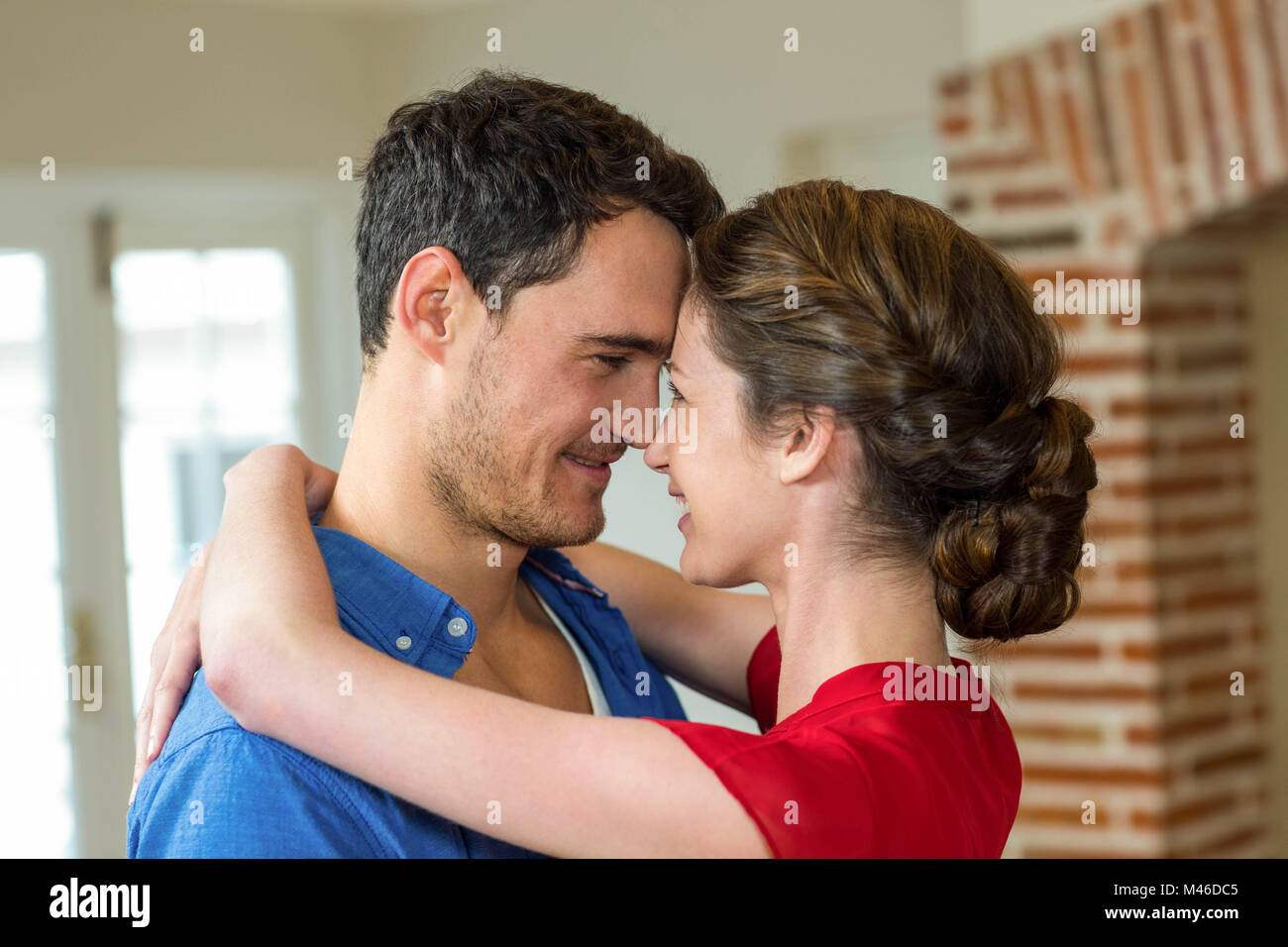 Romantic couple standing face to face and embracing each other Stock ...
