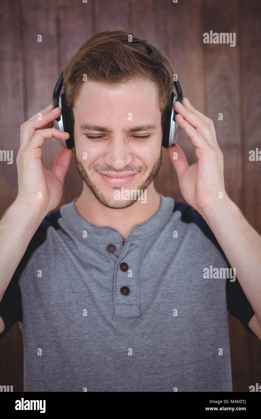 Handsome hipster listening to music with headphones Stock Photo - Alamy