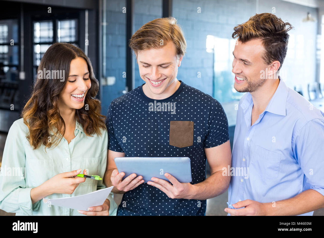 Three confident colleagues discussing in office Stock Photo - Alamy