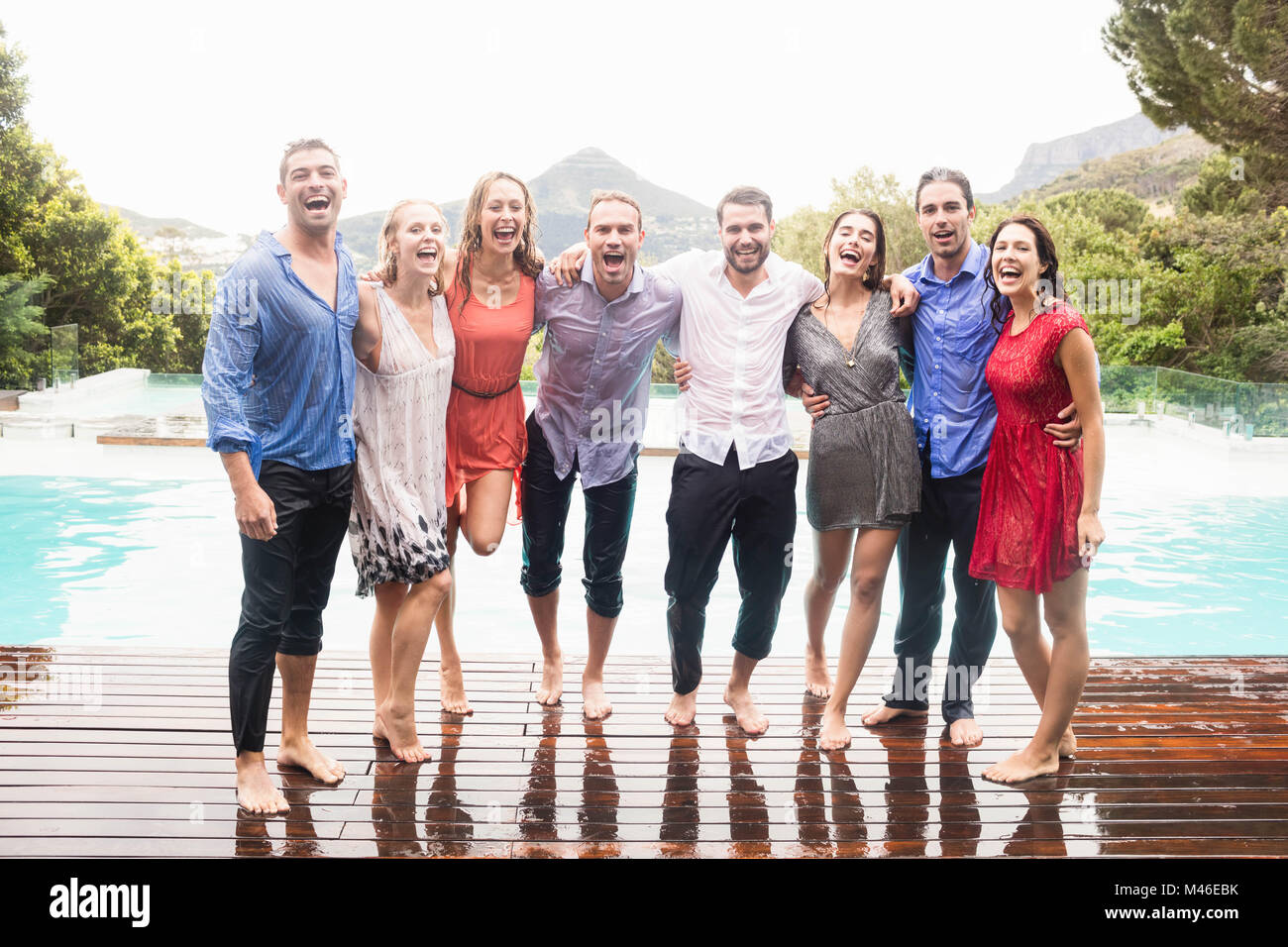 Beautiful young people standing near swimming pool Stock Photo - Alamy