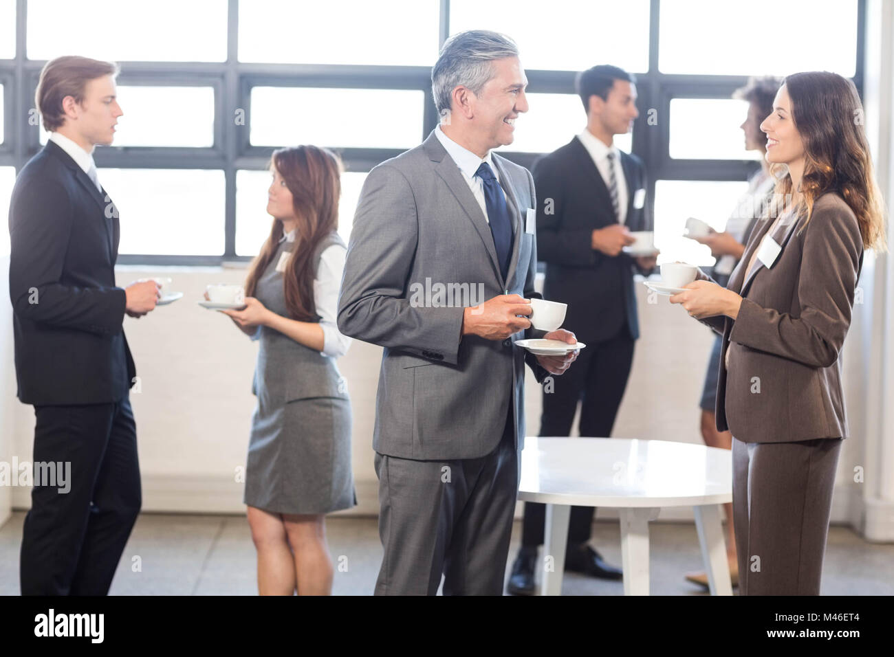 Businesspeople having a discussion during breaktime Stock Photo - Alamy