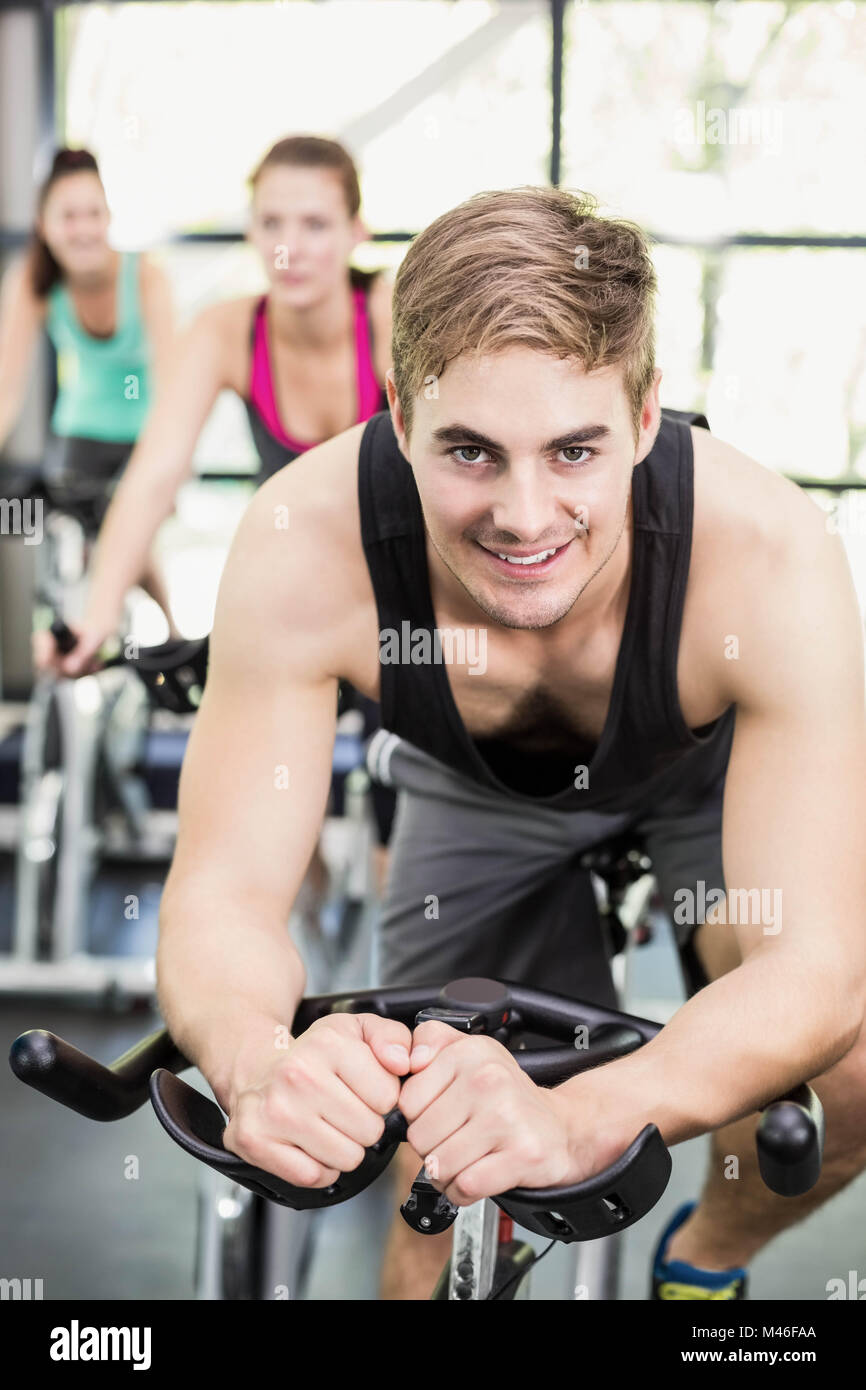 Fit group of people using exercise bike together Stock Photo - Alamy