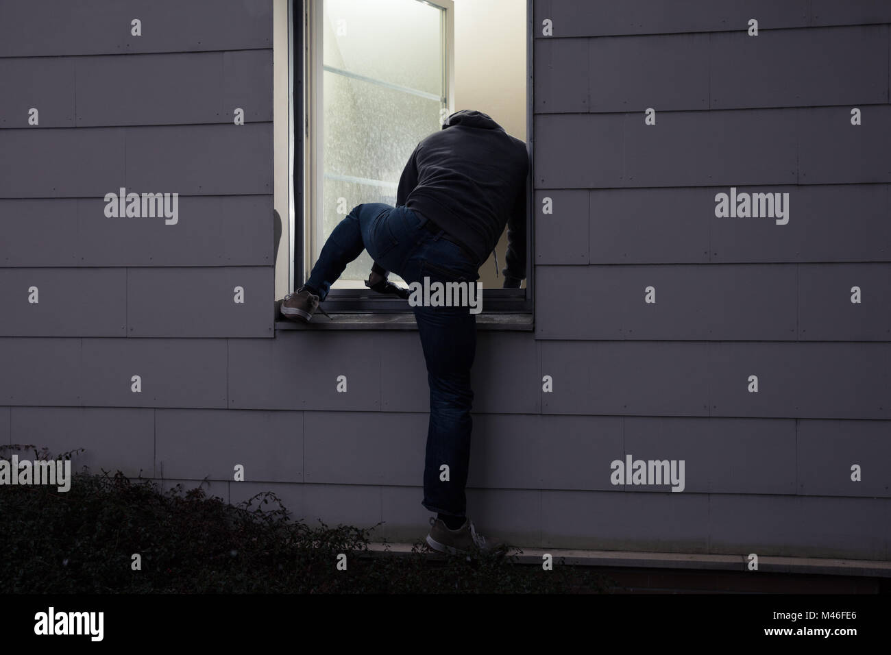 Man climbing window hi-res stock photography and images - Alamy