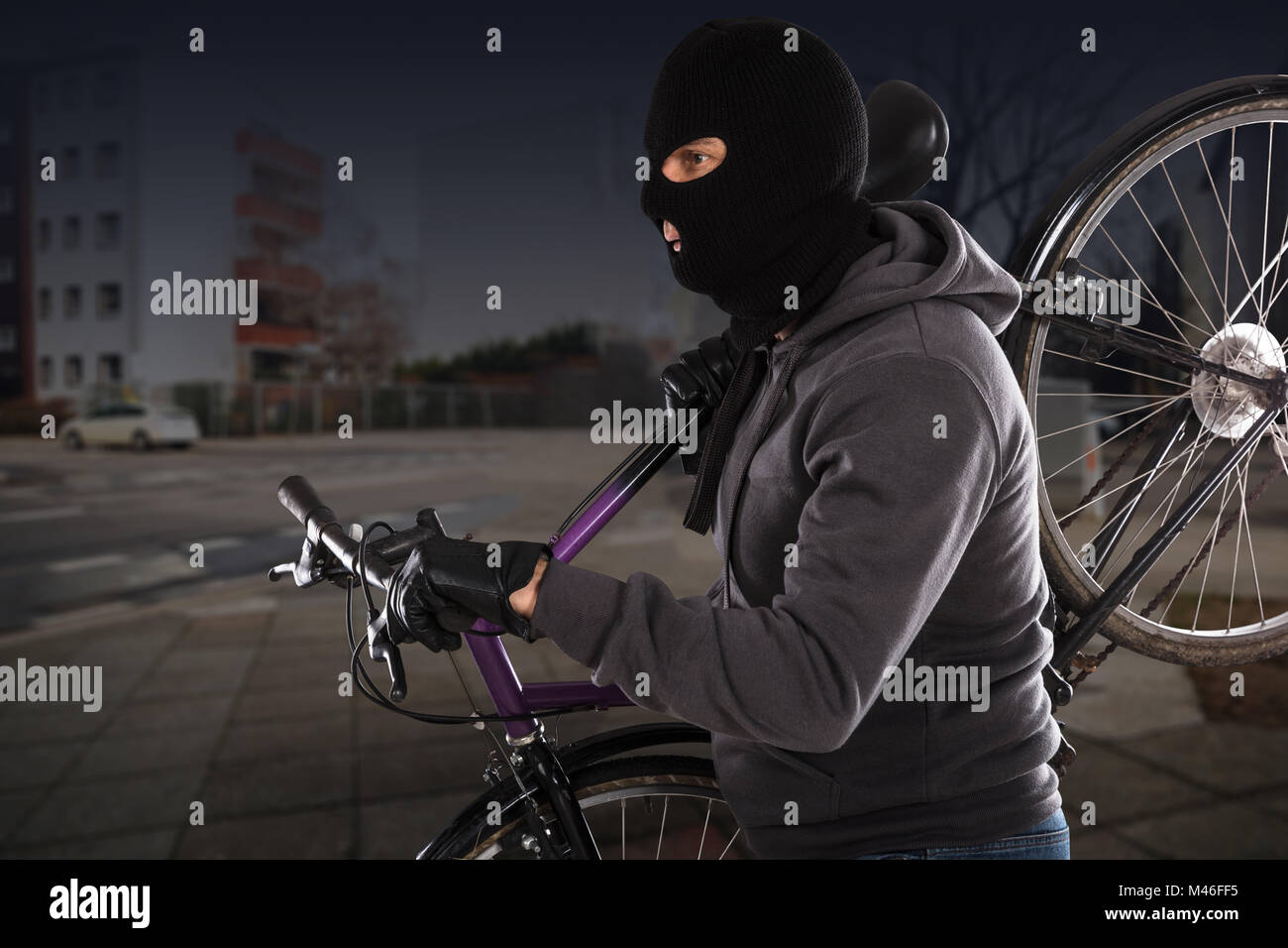 Thief Wearing Balaclava Stealing A Cycle On Street Stock Photo - Alamy