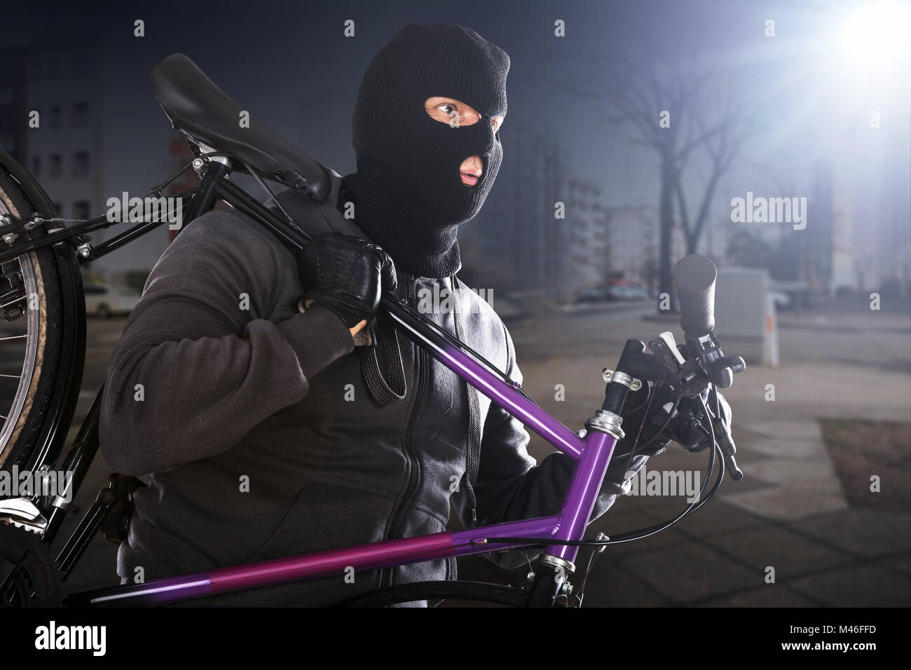 Thief Wearing Balaclava Stealing A Cycle On Street Stock Photo - Alamy