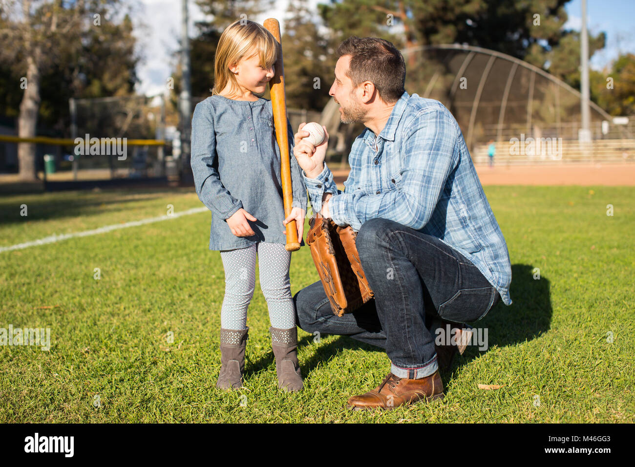 Father coach teach daughter baseball Stock Photo - Alamy