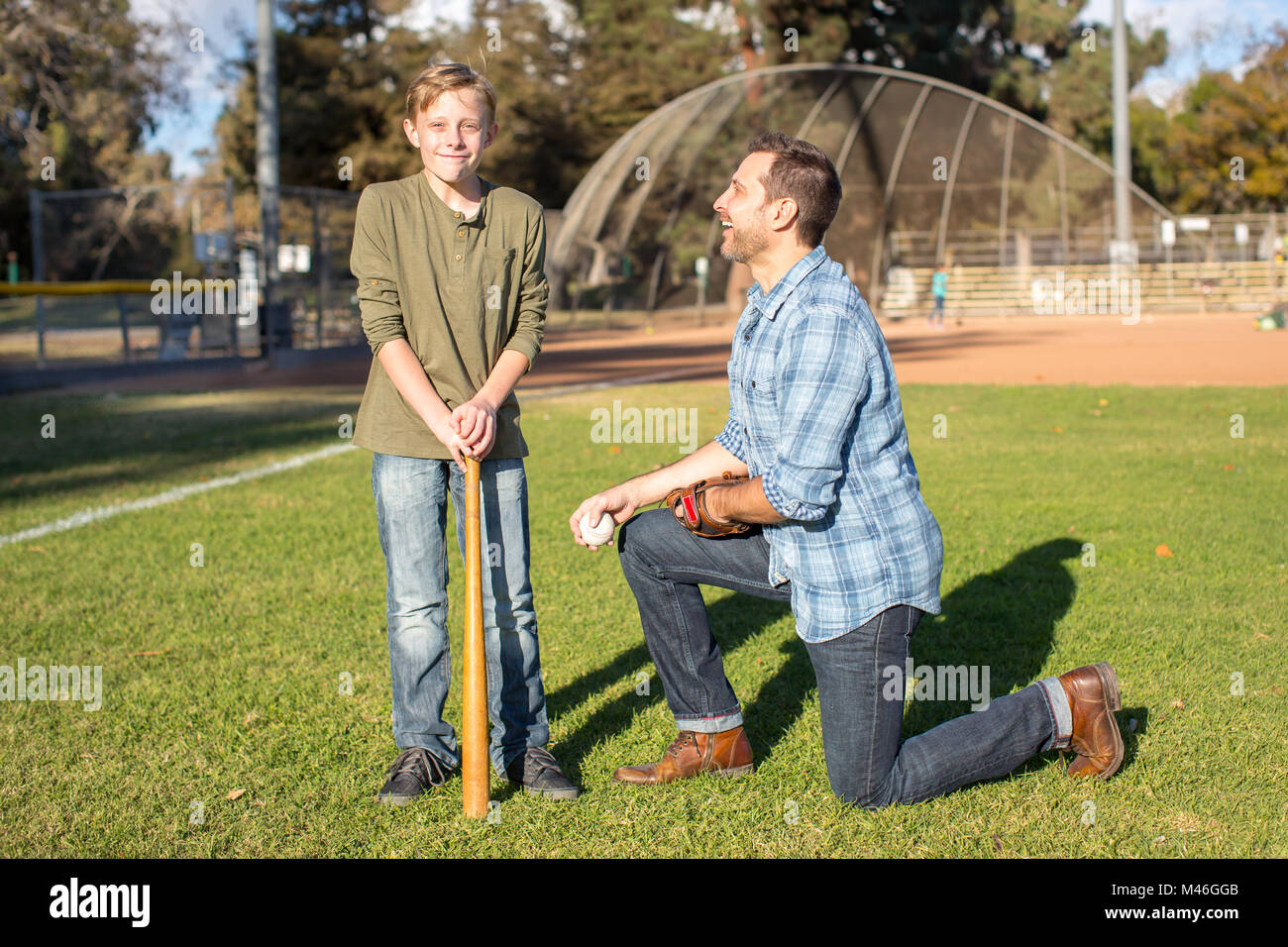 Father coach teaching son baseball Stock Photo - Alamy