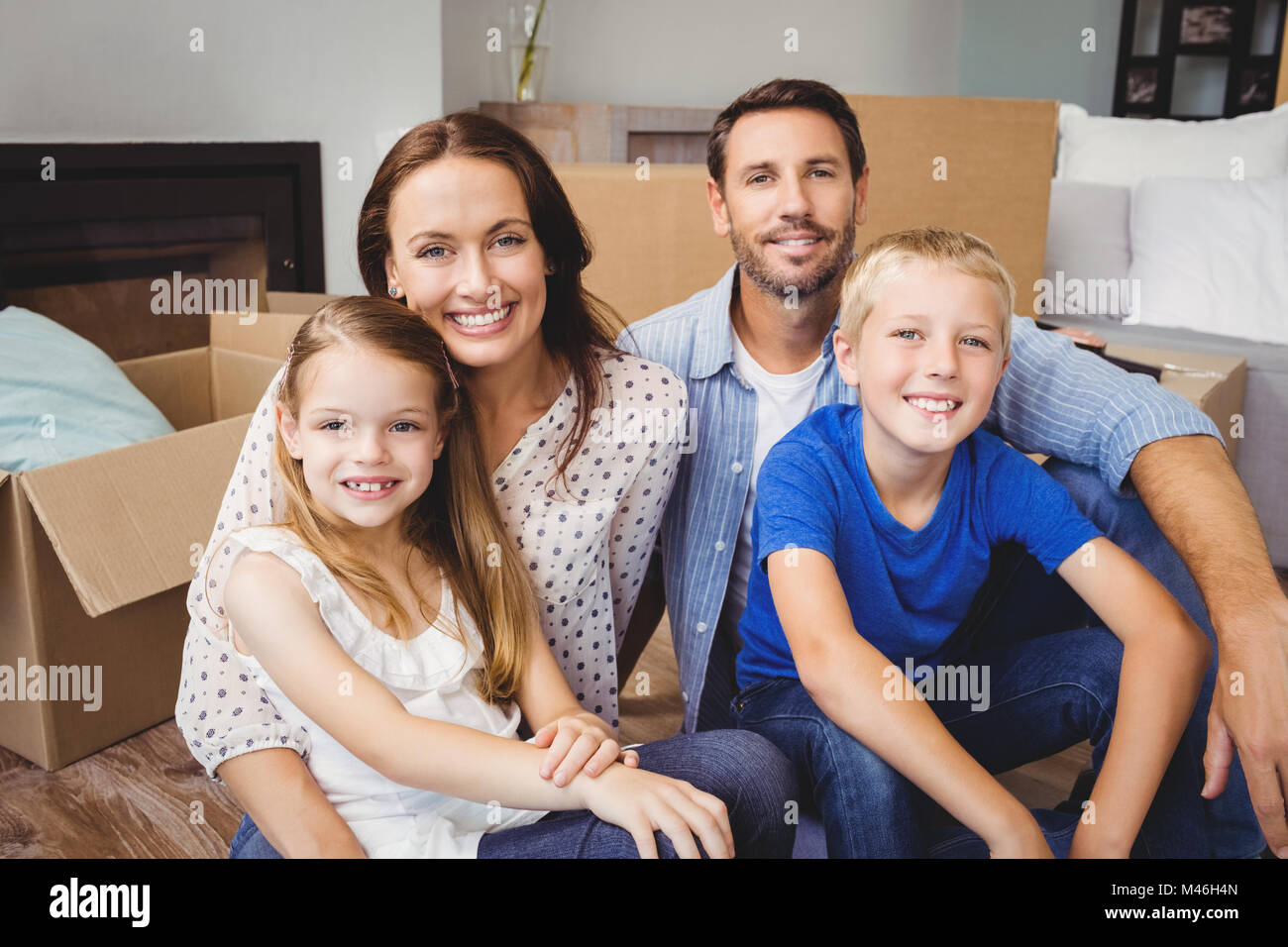 Portrait of smiling family with cardboard boxes Stock Photo - Alamy