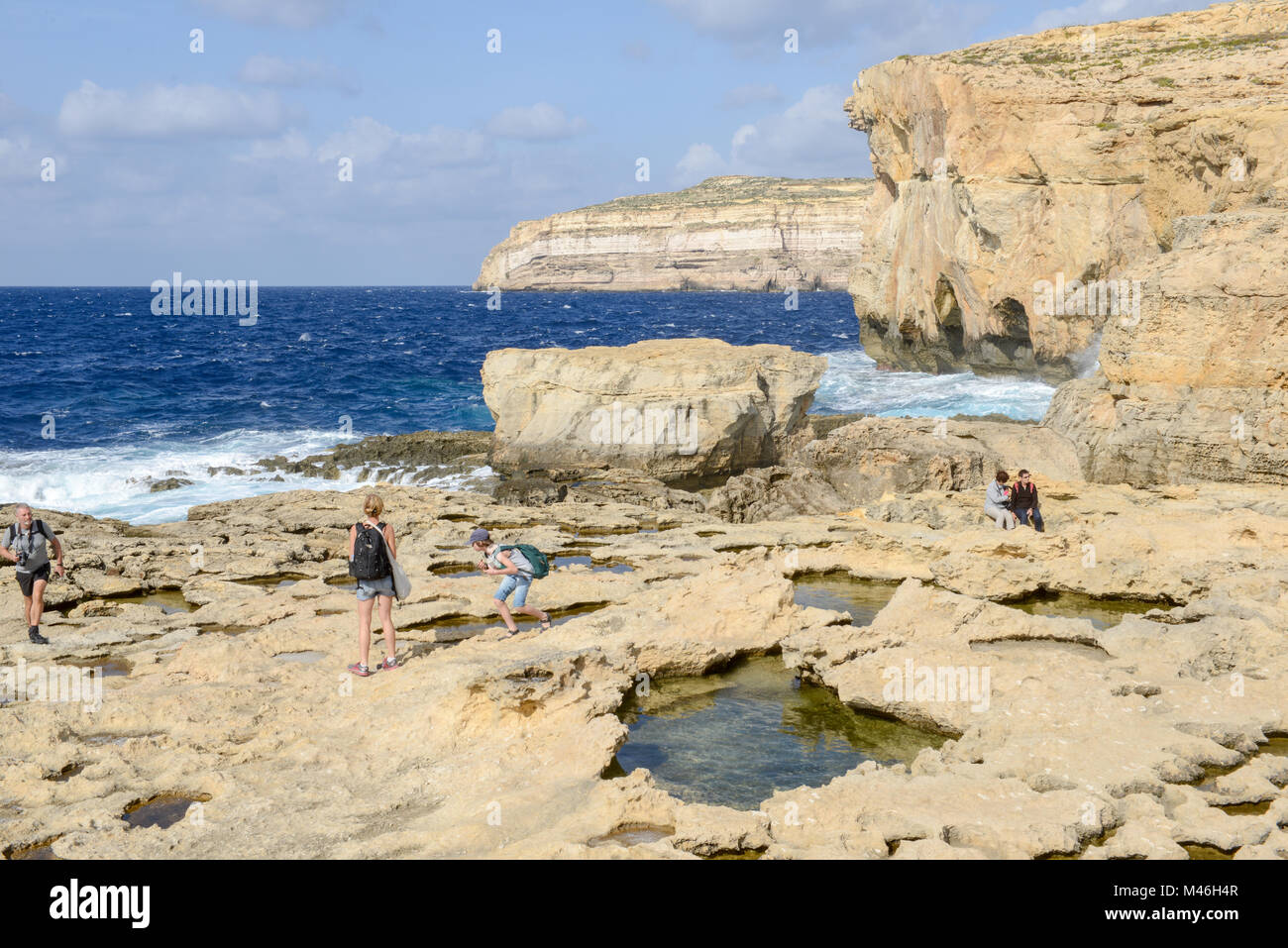 Gozo island, Malta - 30 October 2017: people walking on the rocky coast ...