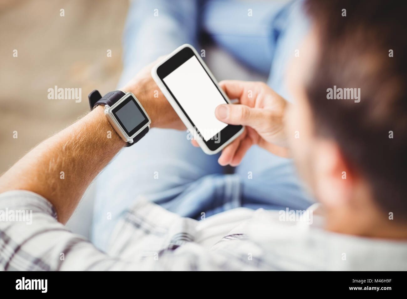 Man wearing smart watch and using mobile phone Stock Photo - Alamy
