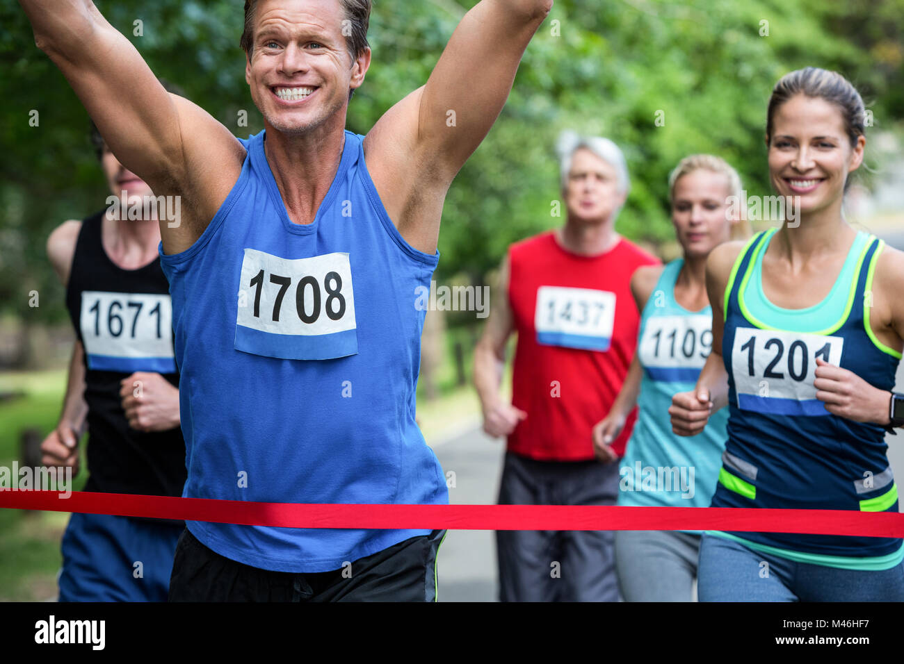 Female athlete crossing finish line hi-res stock photography and images ...