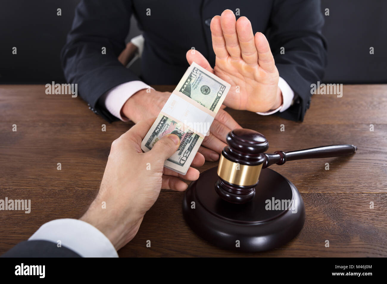 Judge Refusing To Take A Bribe From Client With Gavel On Wooden Desk ...