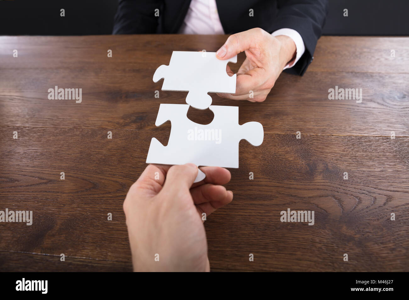 Business people connecting puzzle pieces hi-res stock photography and ...