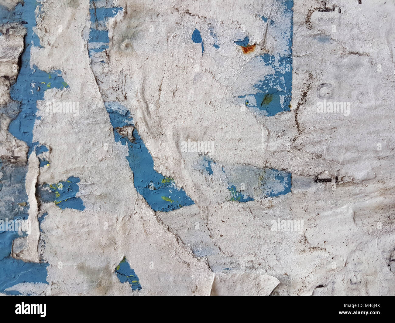 Crumpled white old paper, pasted on layers on a blue wall, trash ...