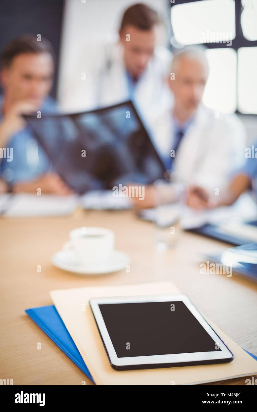 Digital tablet and file on table in conference room Stock Photo - Alamy