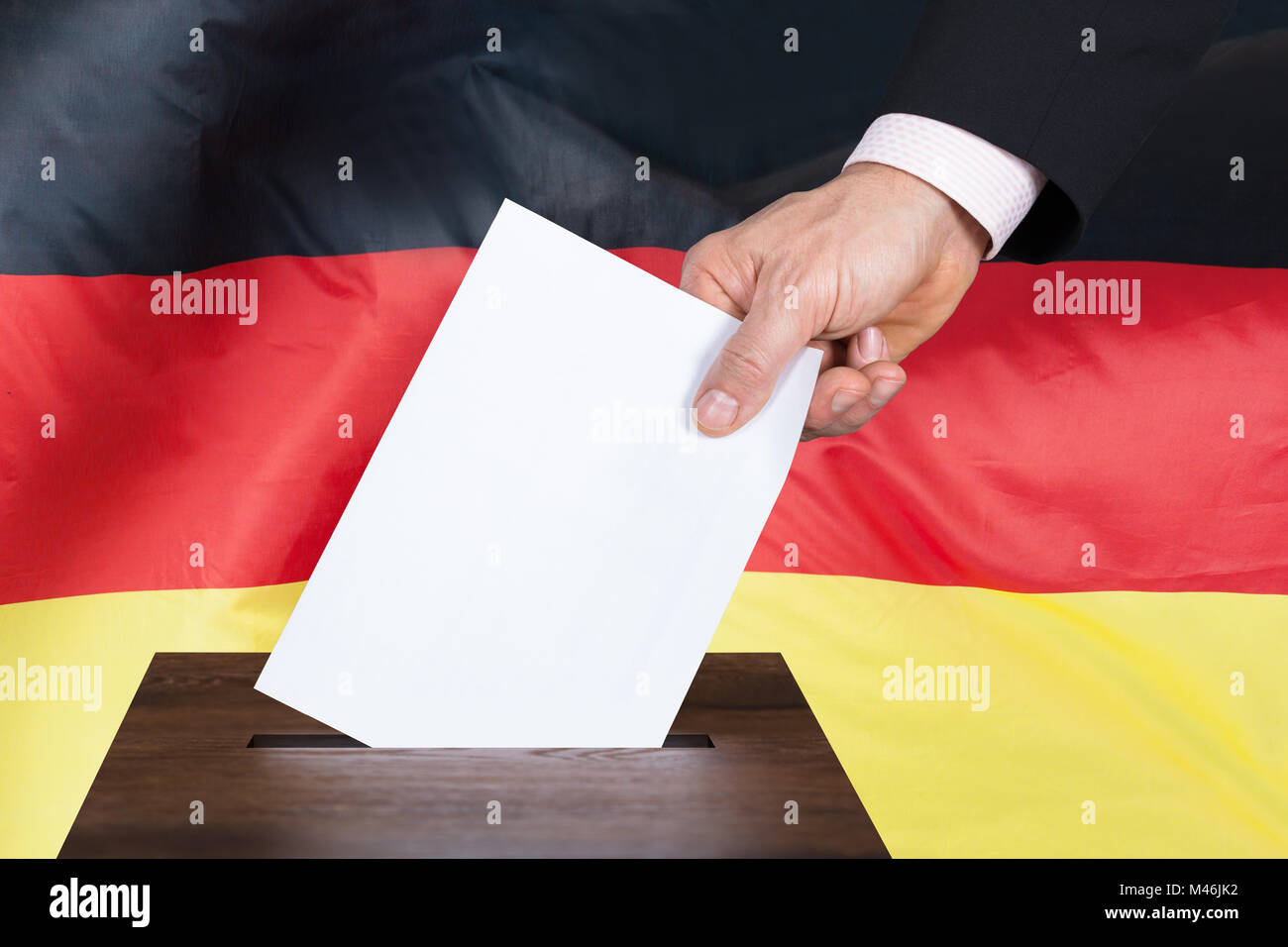 Close-up Of A Person Putting Vote In A Ballot Box In Front Of German ...