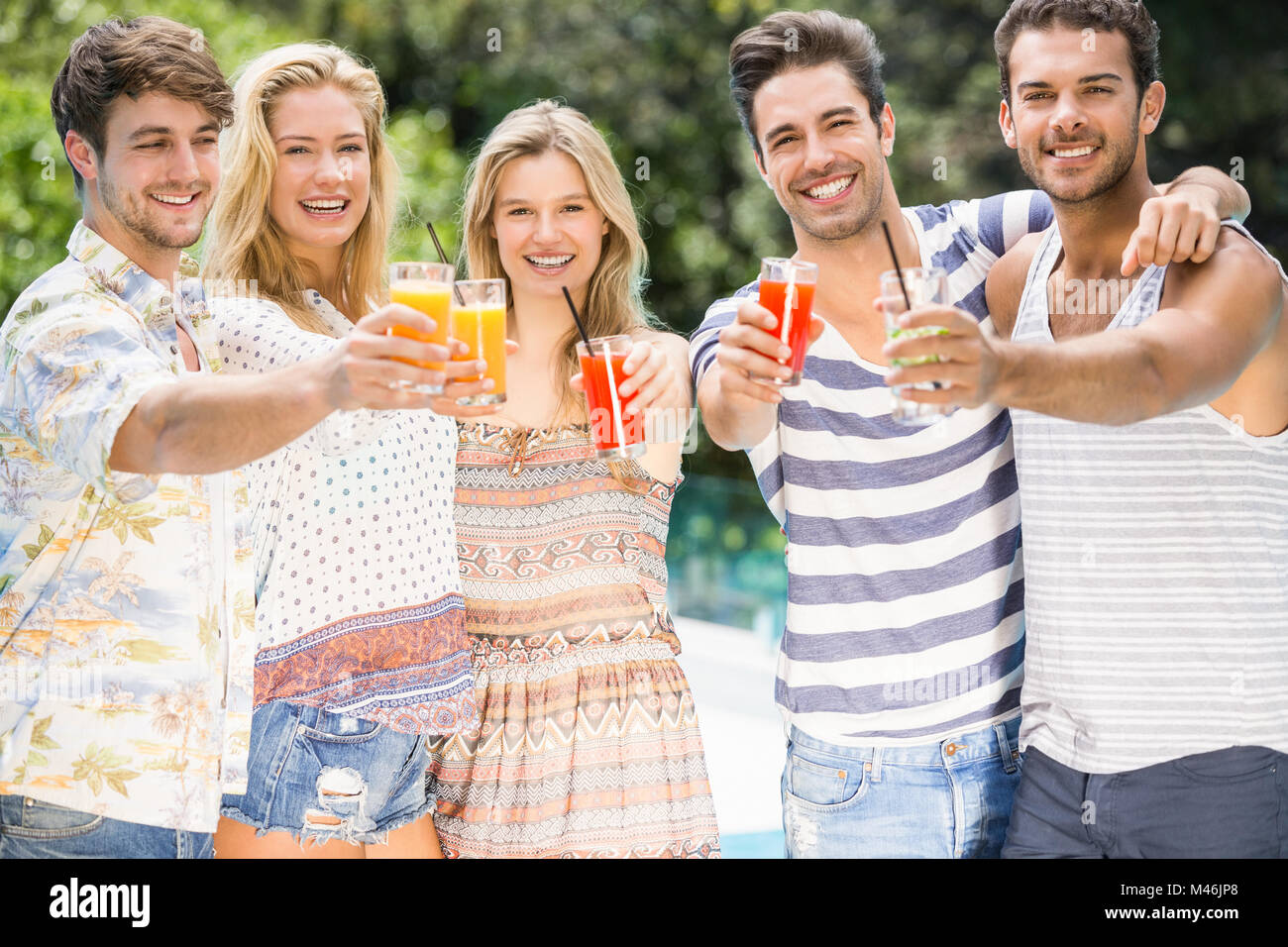 Group of friends showing their glass of juice Stock Photo - Alamy