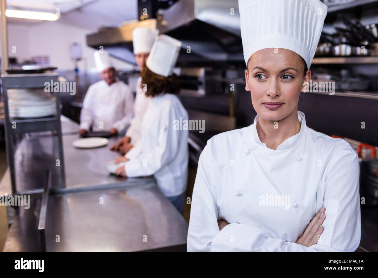 Chef standing in commercial kitchen in a restaurant Stock Photo - Alamy