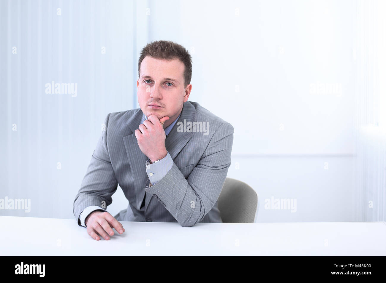 Boss sitting behind desk standing hi-res stock photography and images ...