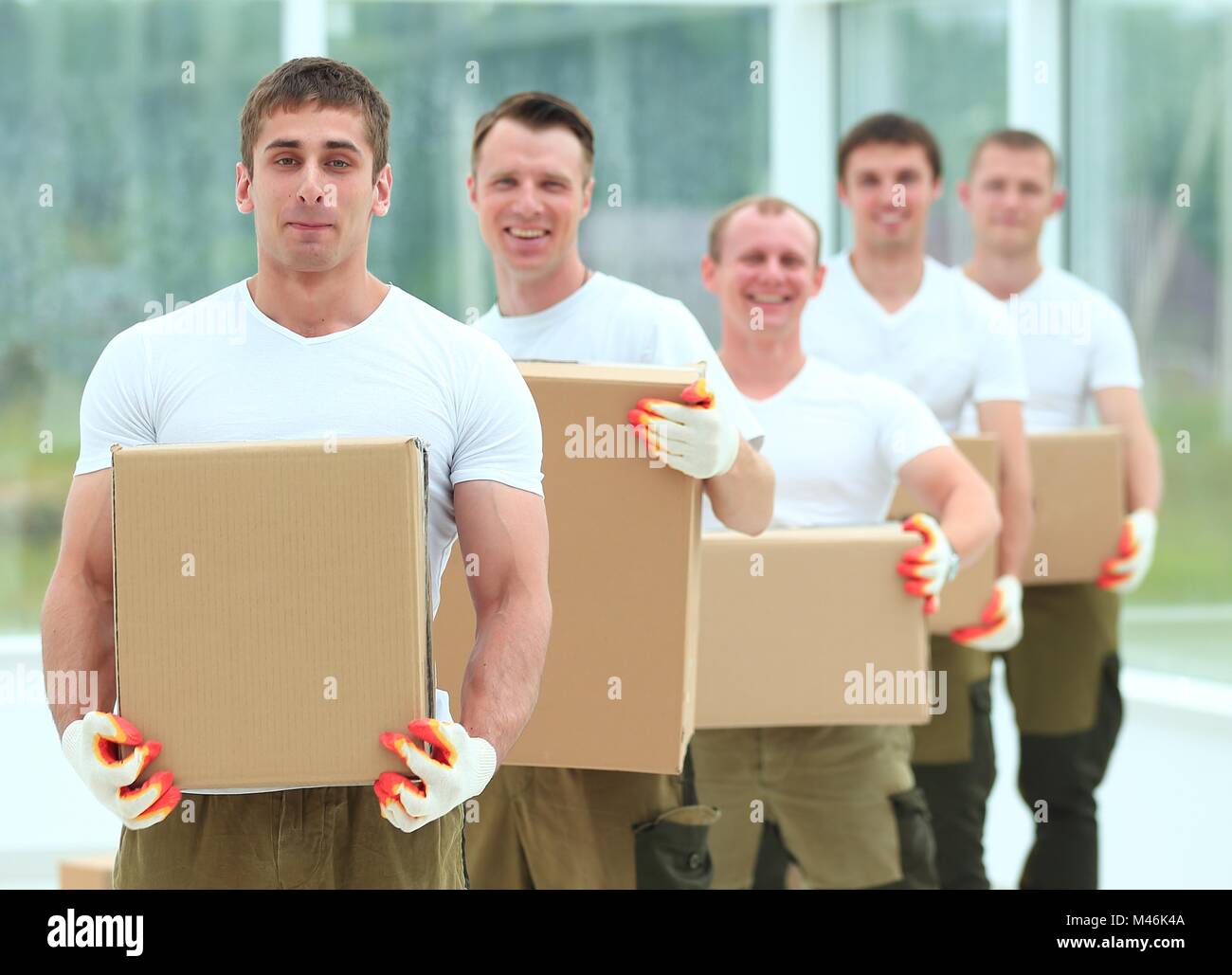 team of builders with boxes of building materials Stock Photo - Alamy