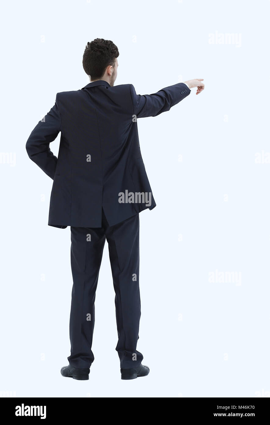 Full length of business man pointing at copyspace Stock Photo - Alamy