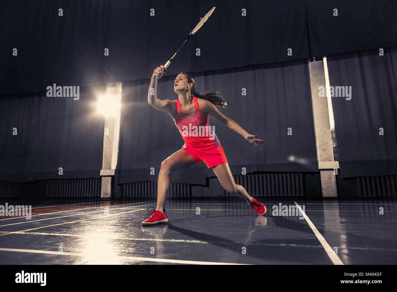 Young woman playing badminton at gym Stock Photo - Alamy