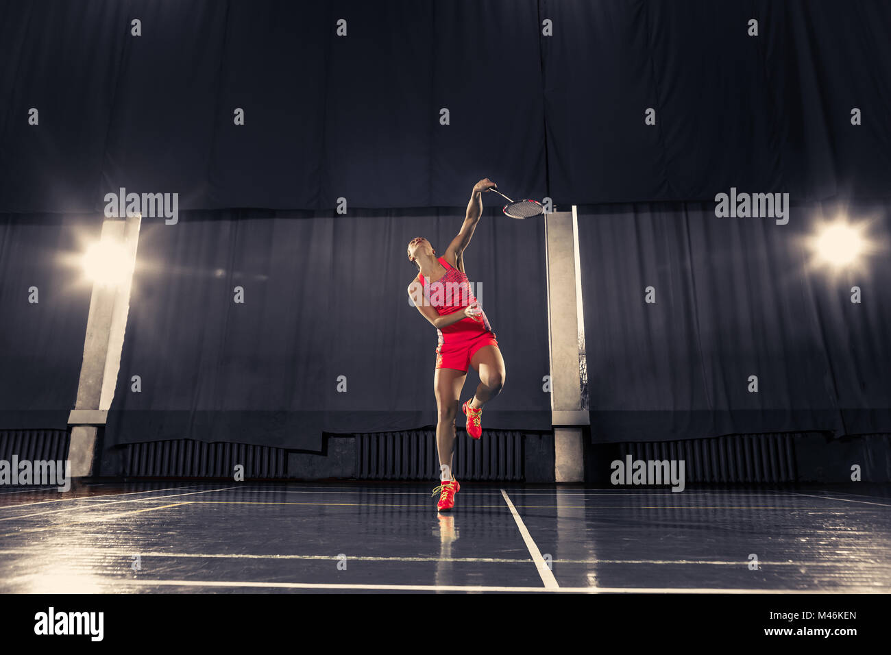 Young woman playing badminton at gym Stock Photo - Alamy