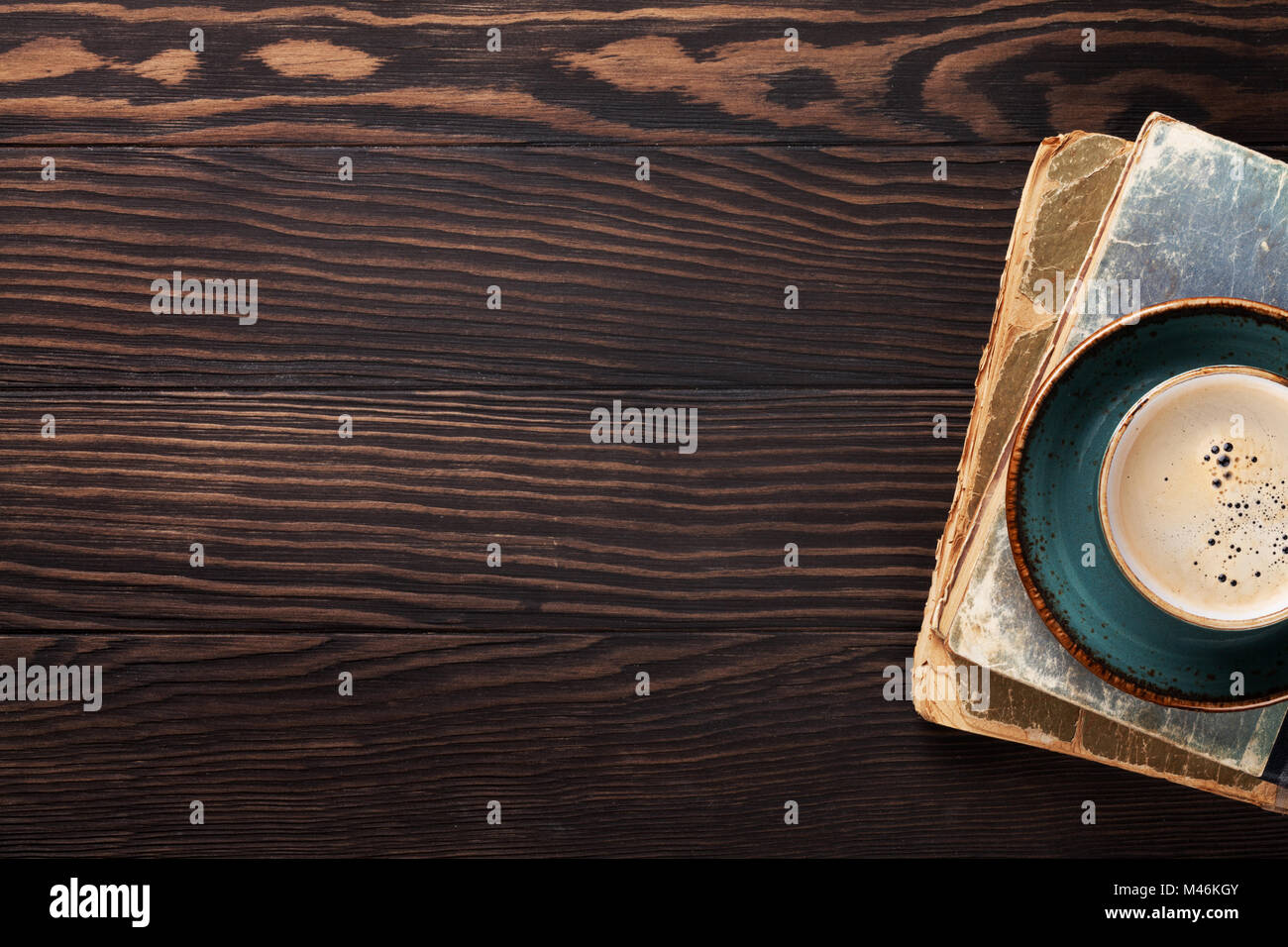 Retro table with vintage items. Old books and coffee cup. Top view with ...