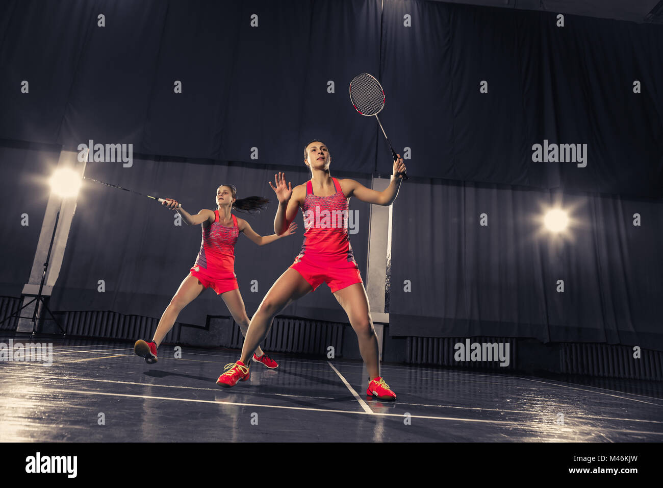 Young women playing badminton at gym Stock Photo - Alamy