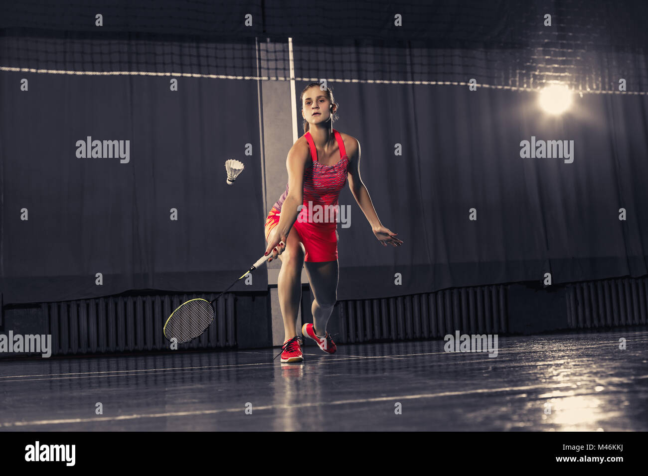 Young woman playing badminton at gym Stock Photo - Alamy