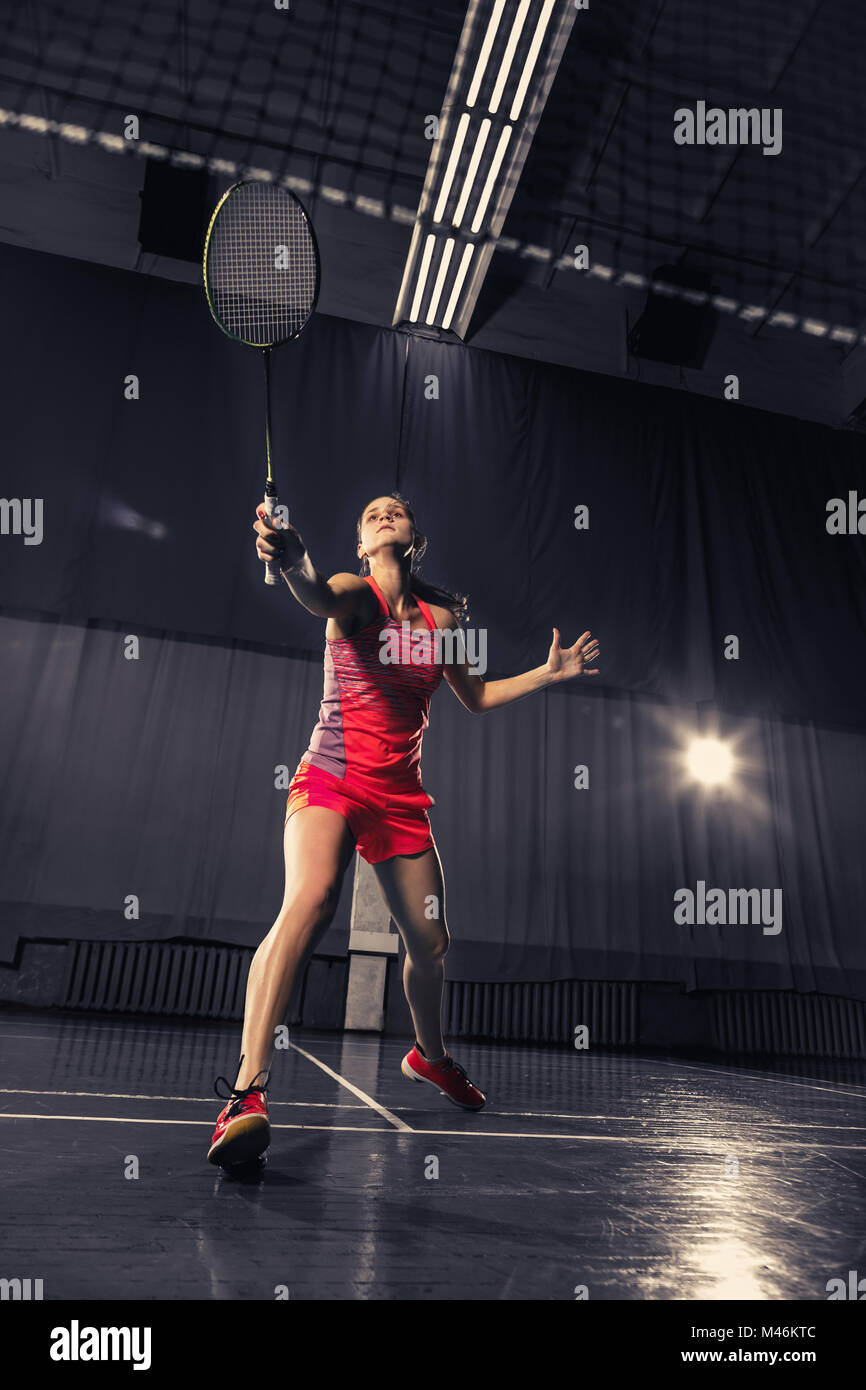 Young woman playing badminton at gym Stock Photo - Alamy