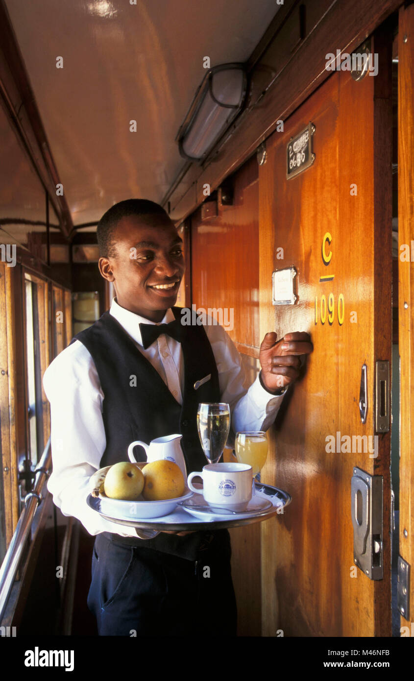 Zimbabwe. Near Bulawayo. Rail safari. Steam train. Waiter serving ...