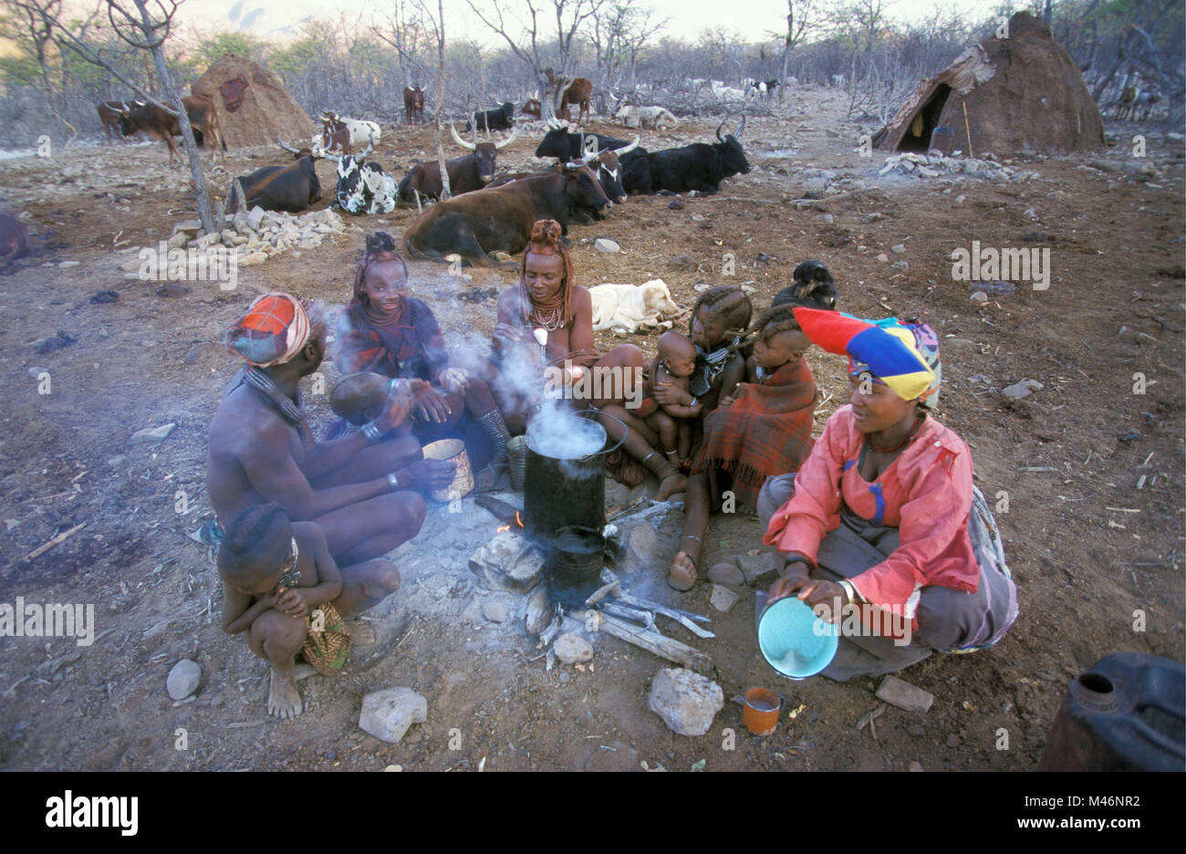 Namibia. Kaokoveld, near Opuwo. Himba tribe. Family at the fire place ...
