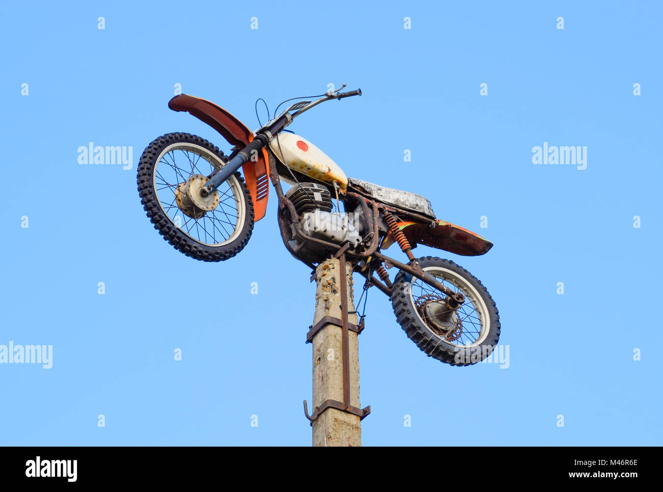 Motorcycle on the pedestal. A light motorbike on a pole, put up as a ...
