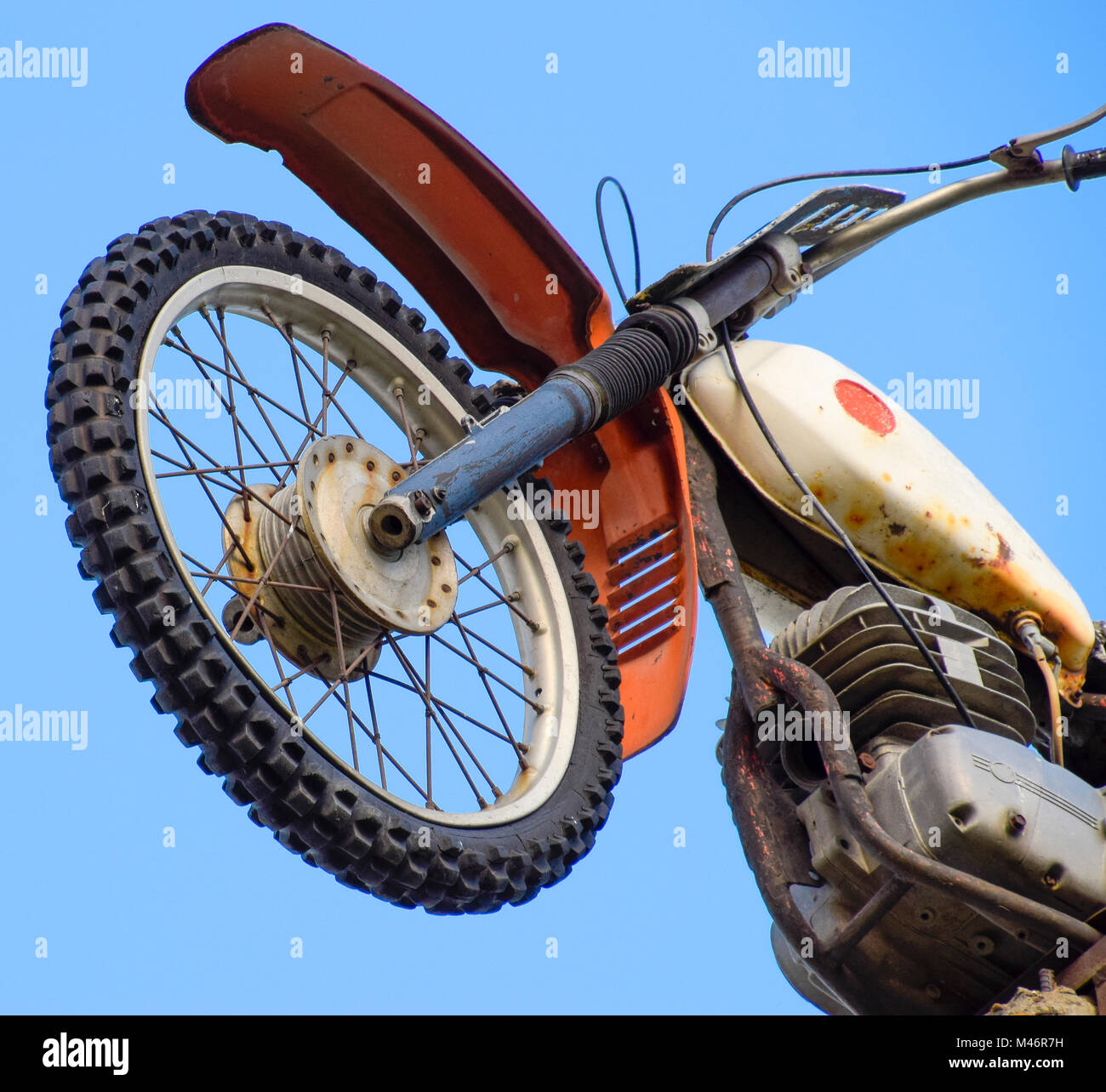 Motorcycle on the pedestal. A light motorbike on a pole, put up as a ...
