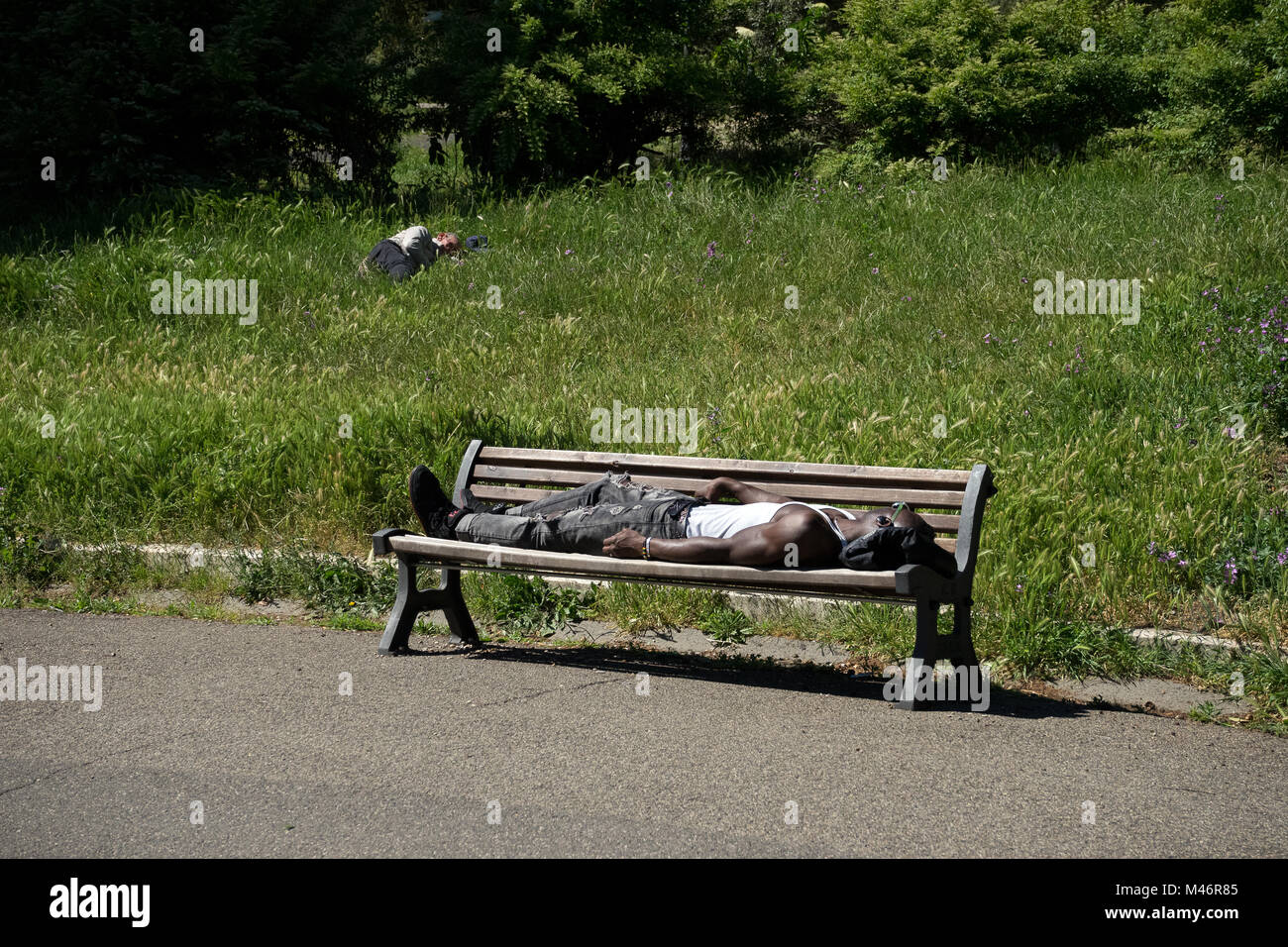 Boy sleeping on bench hi-res stock photography and images - Alamy