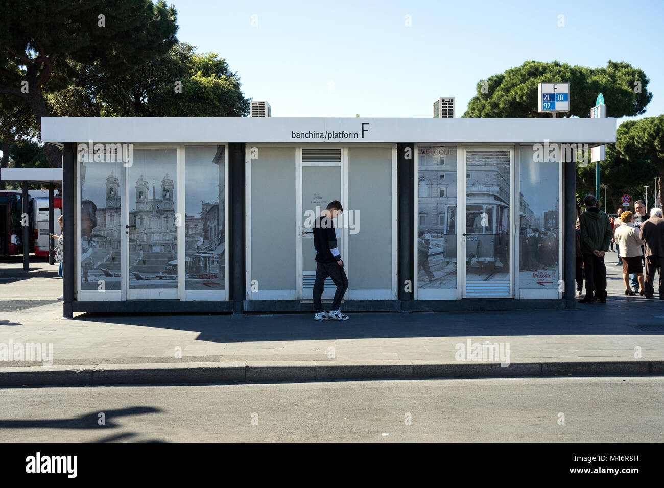 Rome, Italy: a boy is waiting at the bus stop Stock Photo - Alamy