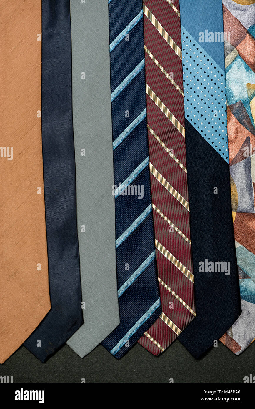 several different colors ties hanging on black background Stock Photo ...