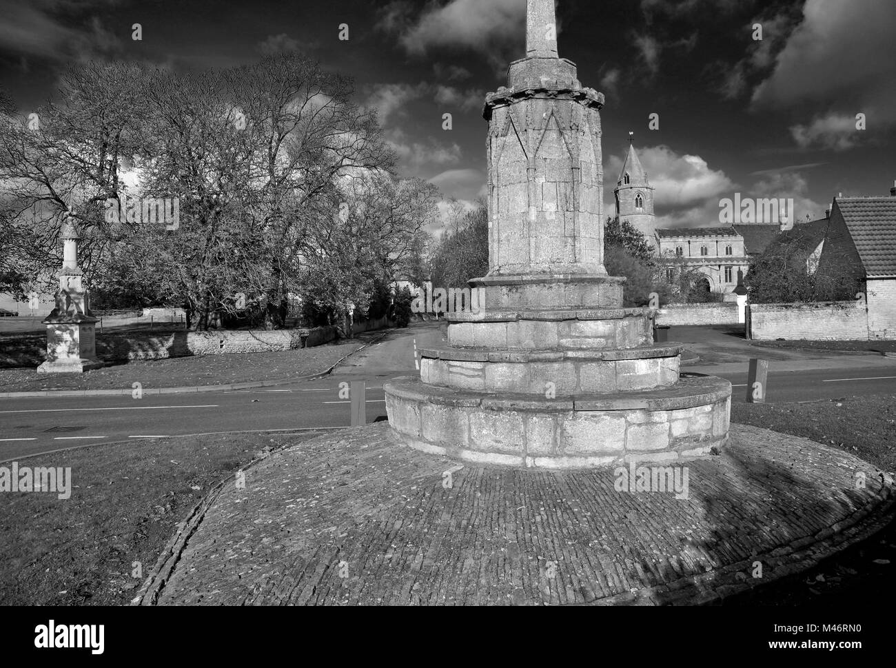 The Market Cross with St Botolphs Church, Helpston village ...